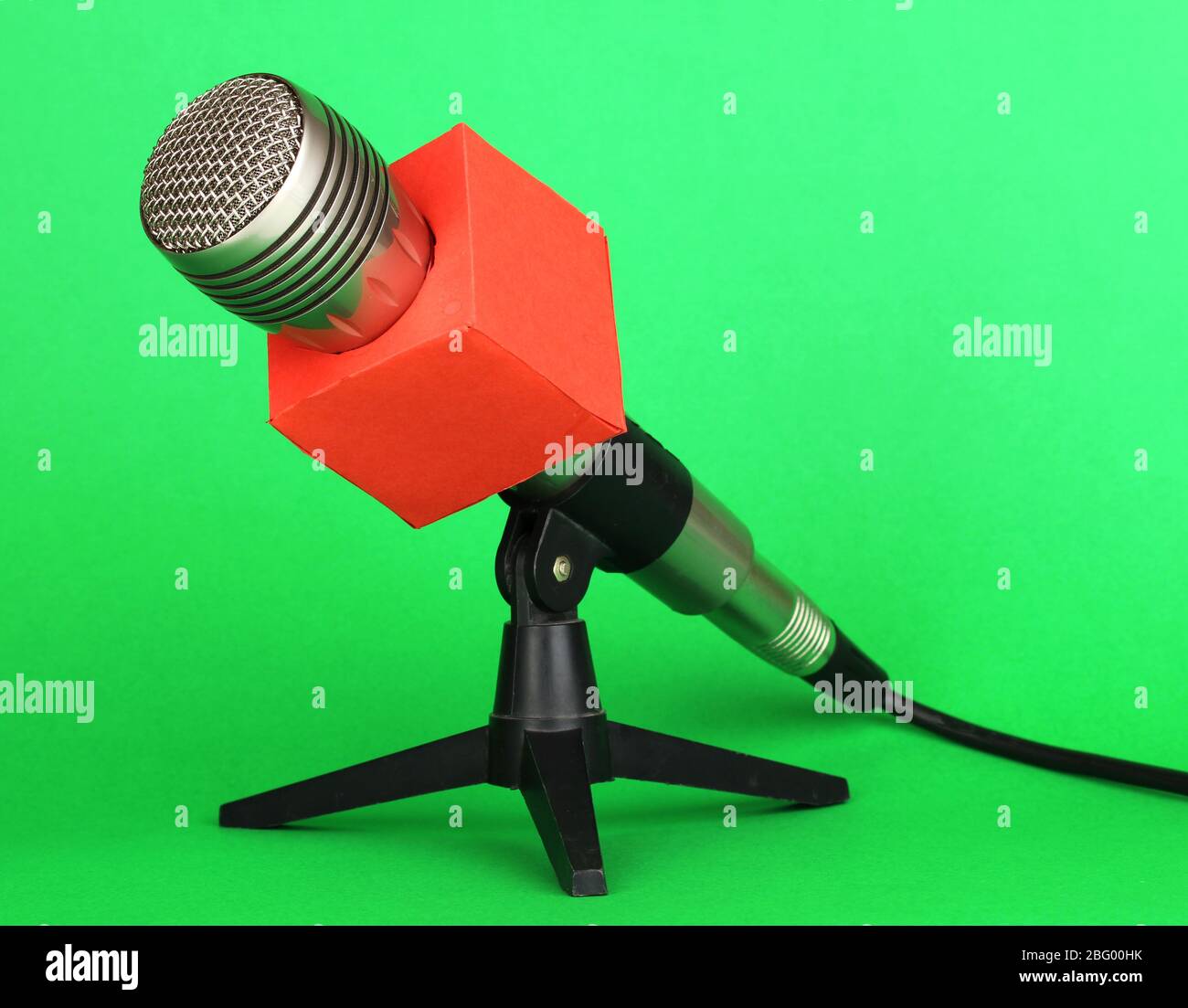 Microphone on stand on green background Stock Photo - Alamy