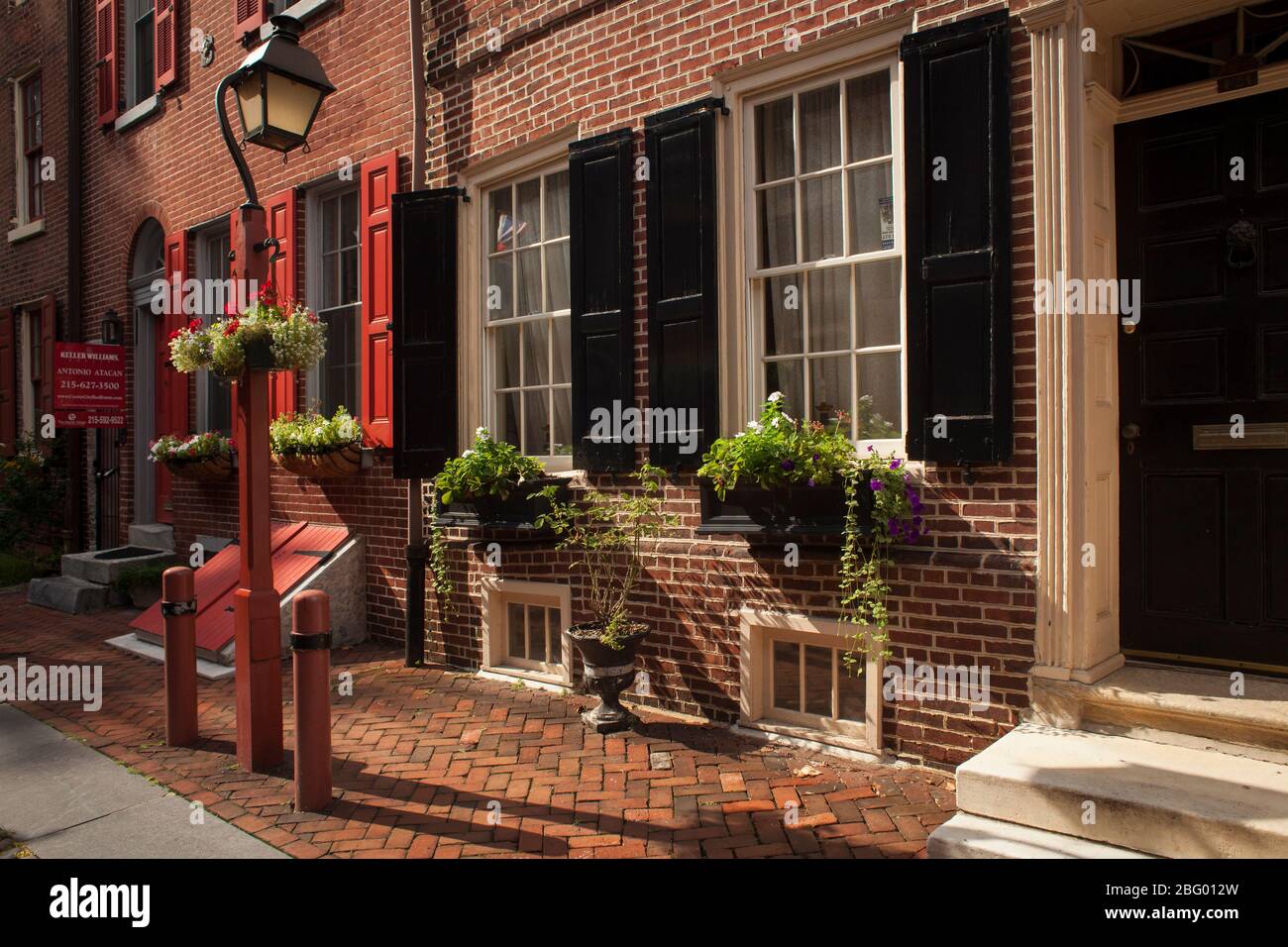 Horizontal view of a streetlight and some flats with wooden shutters in ...
