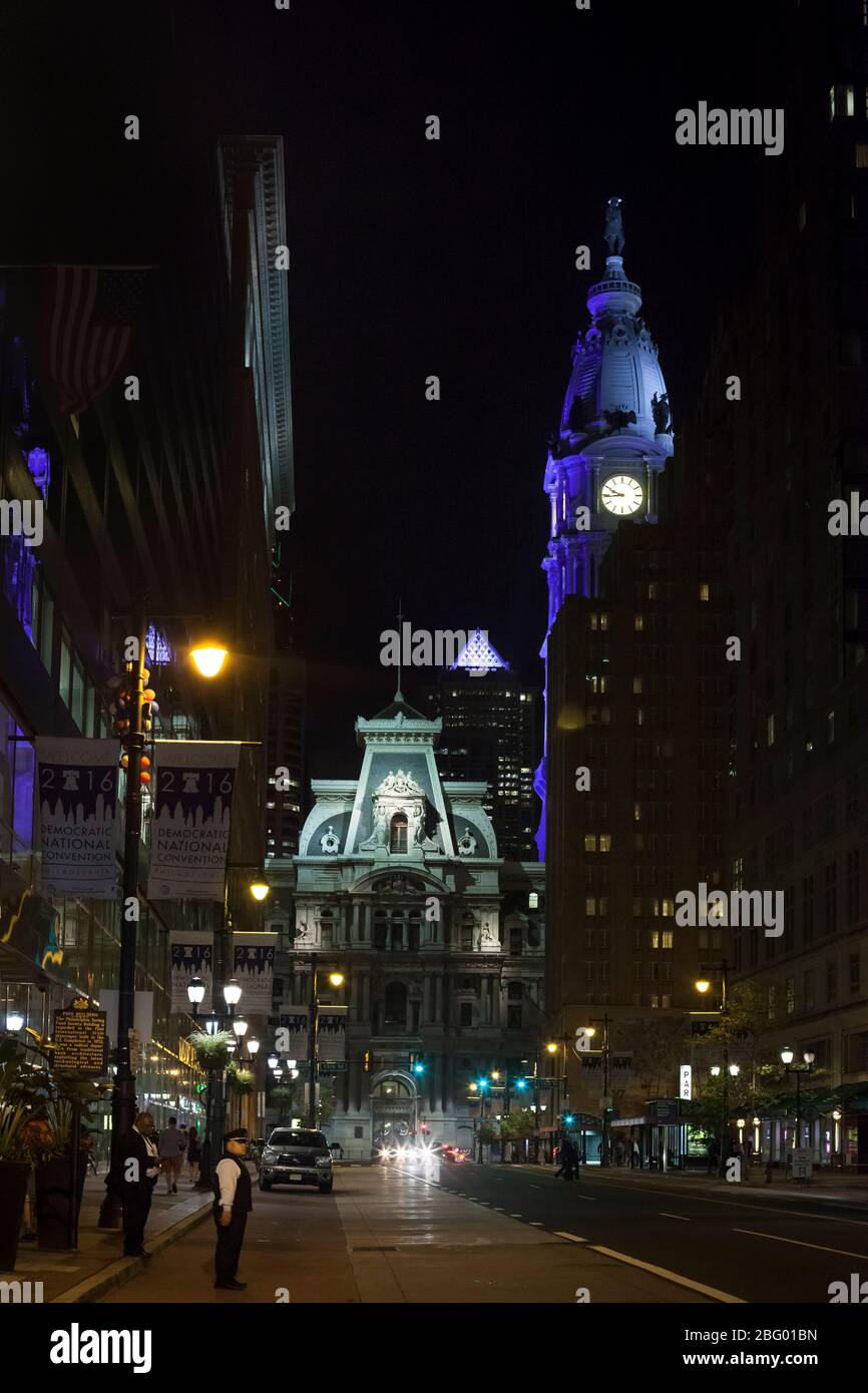 Vertical night view of Market St with the City Hall building in the ...