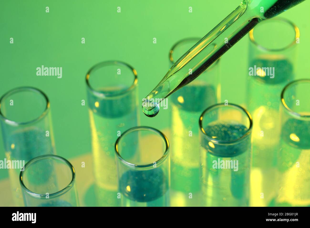 test-tubes with liquid on blue background Stock Photo - Alamy