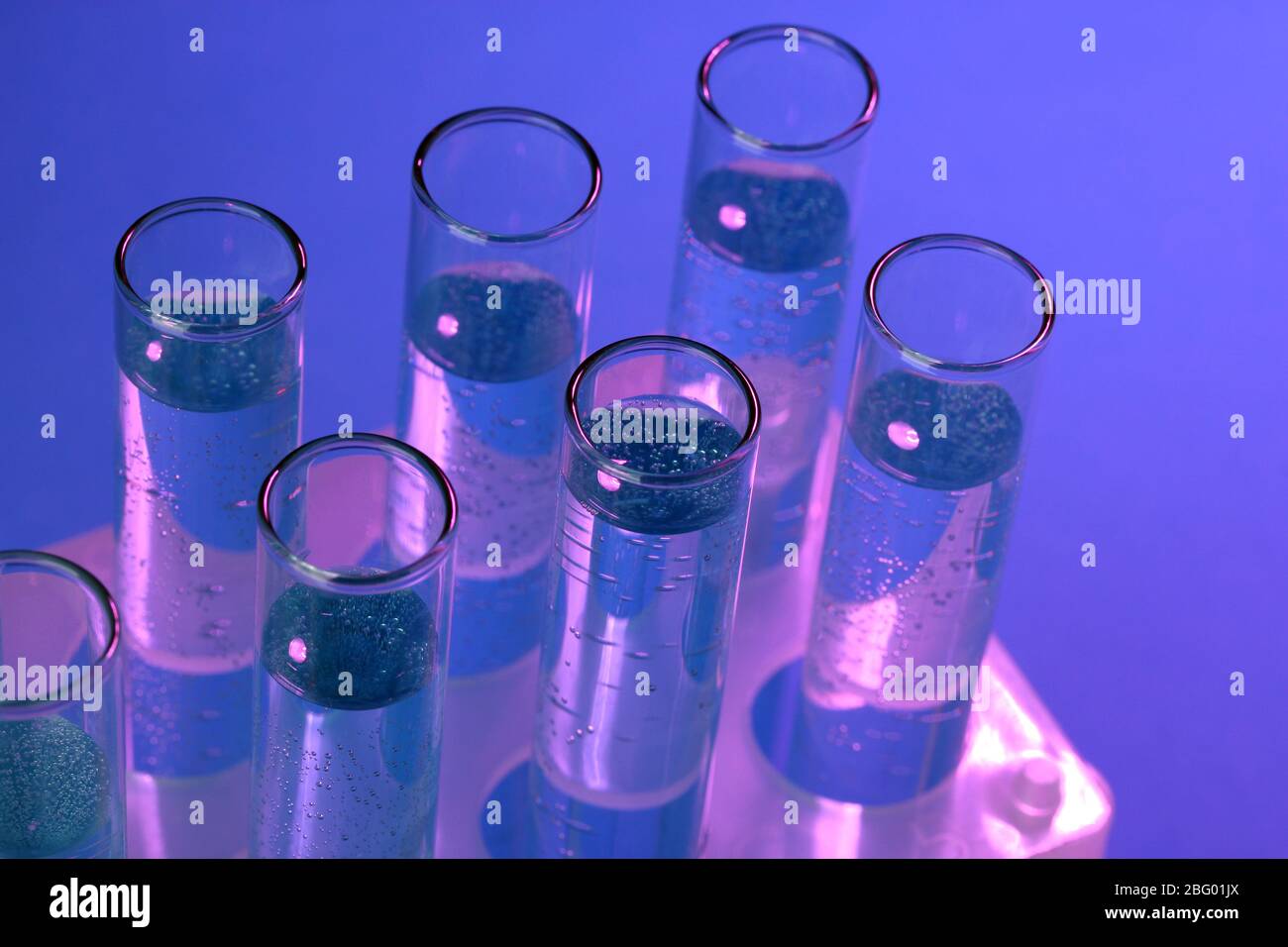 test-tubes with liquid on blue background Stock Photo - Alamy