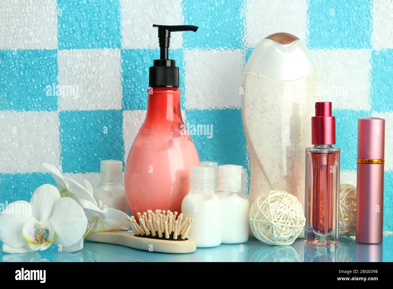 Bath accessories on shelf in bathroom on blue tile wall background ...