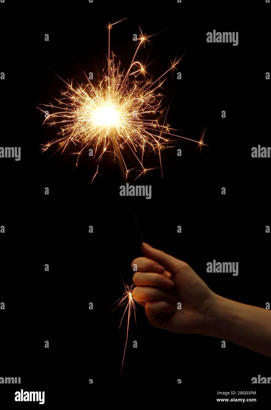 Sparkler burning sparks in hand hi-res stock photography and images - Alamy