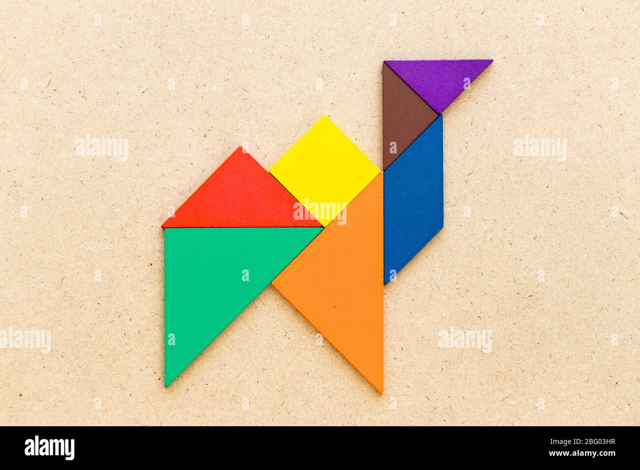 Color tangram in camel shape on wood background Stock Photo - Alamy