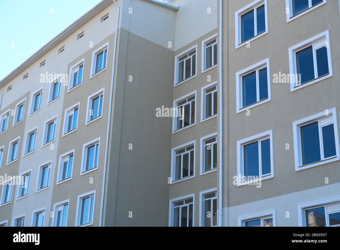 facade of a new multi-storey building with many windows Stock Photo - Alamy