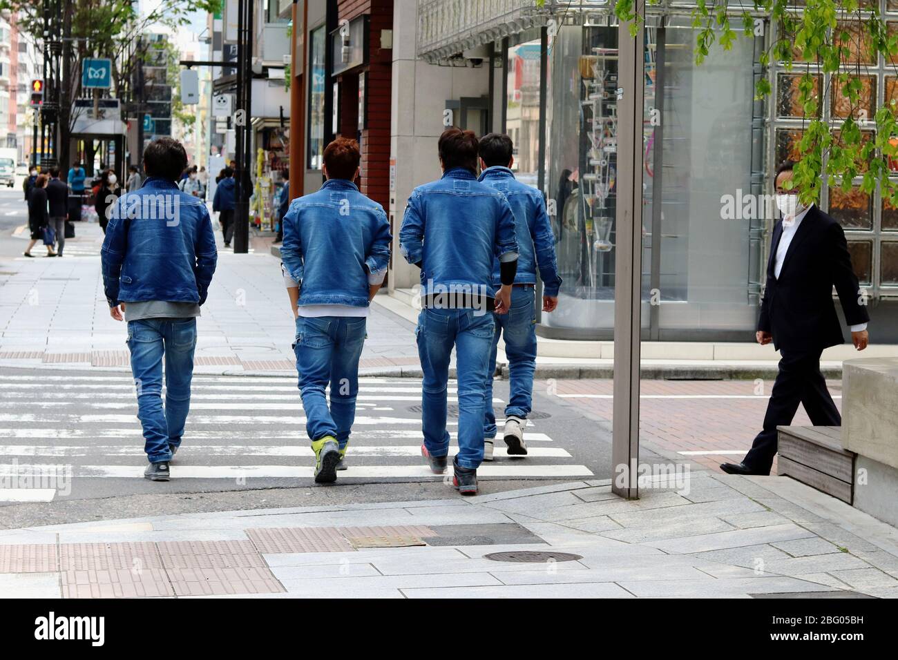 People on an unusually quiet street in Ginza. Due to the coronavirus ...