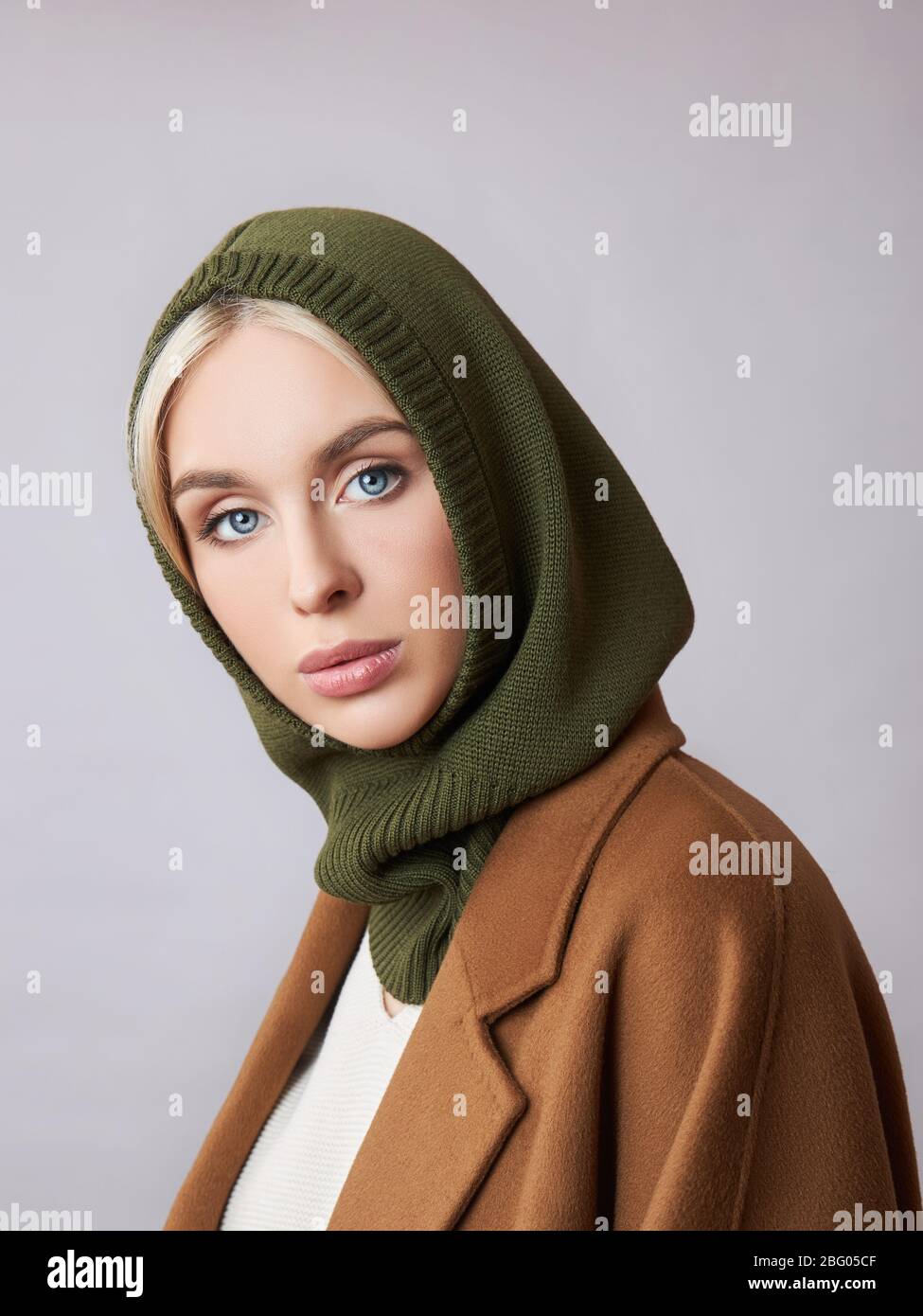 European Muslim woman with a blonde hair in a bonnet hood dressed on ...