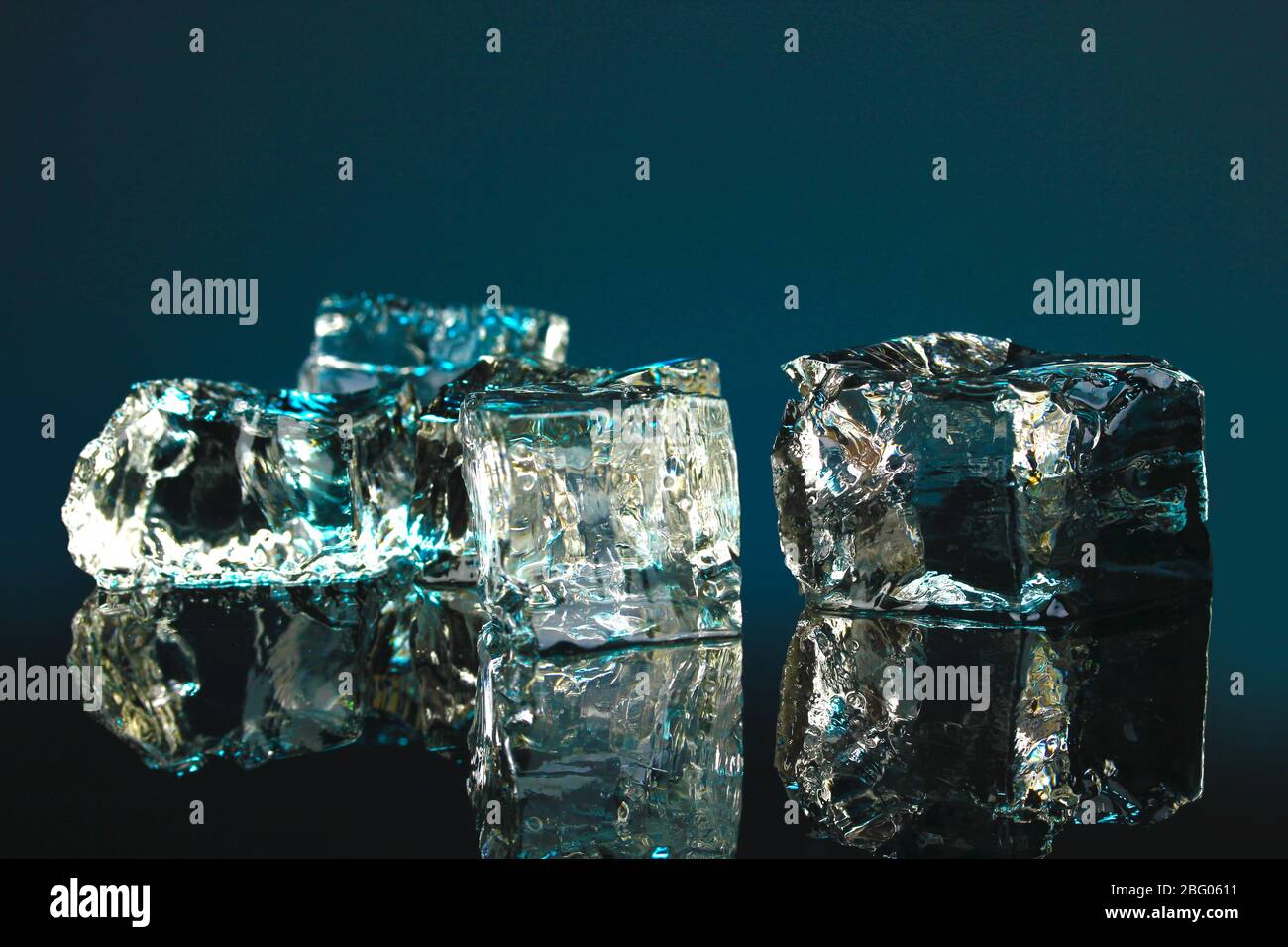 Ice cubes on dark blue background Stock Photo - Alamy