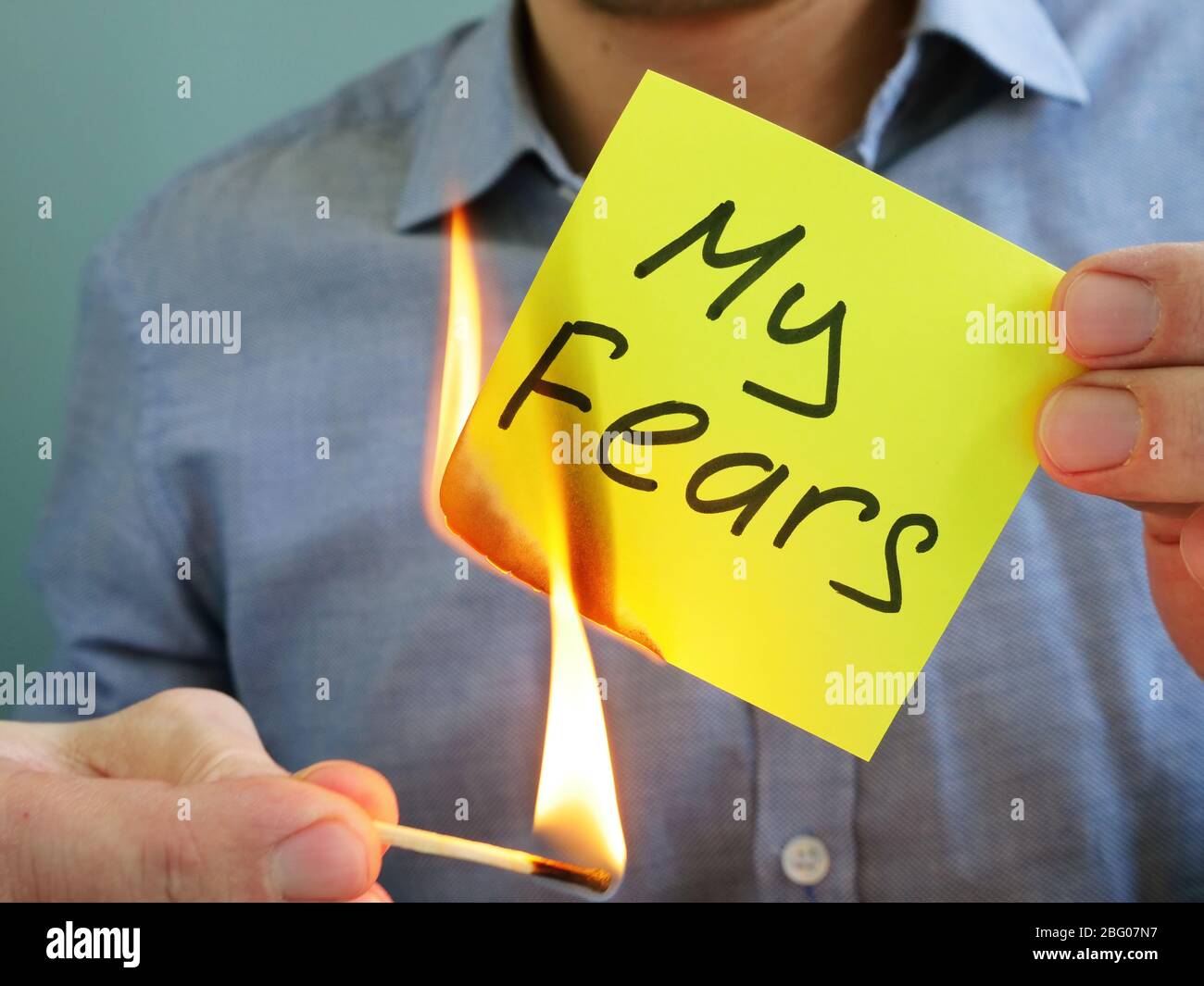 Man burns fears. Face and conquer them as motivation Stock Photo - Alamy
