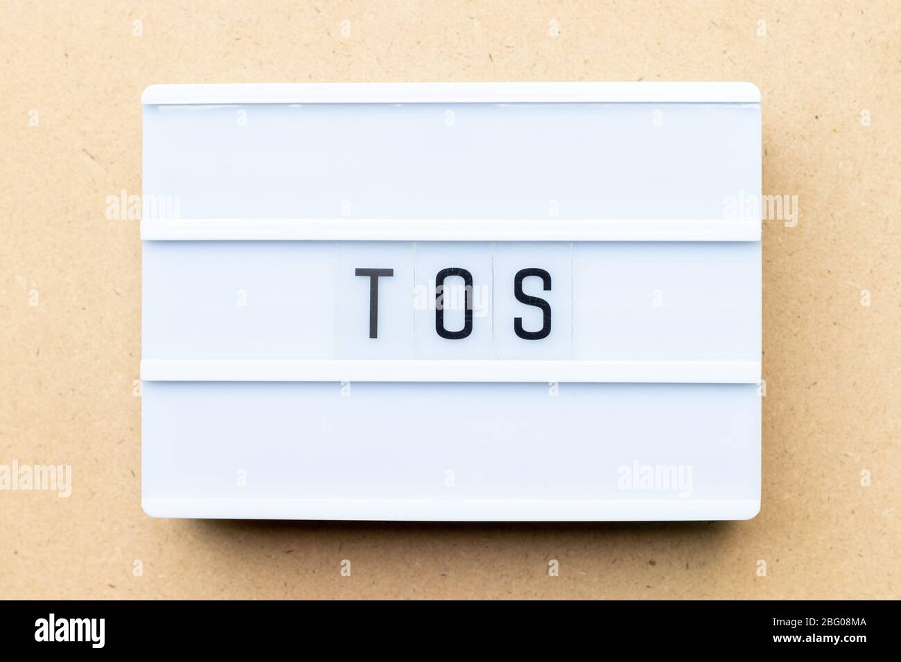 White lightbox with word TOS (abbreviation of Terms of service) on wood ...