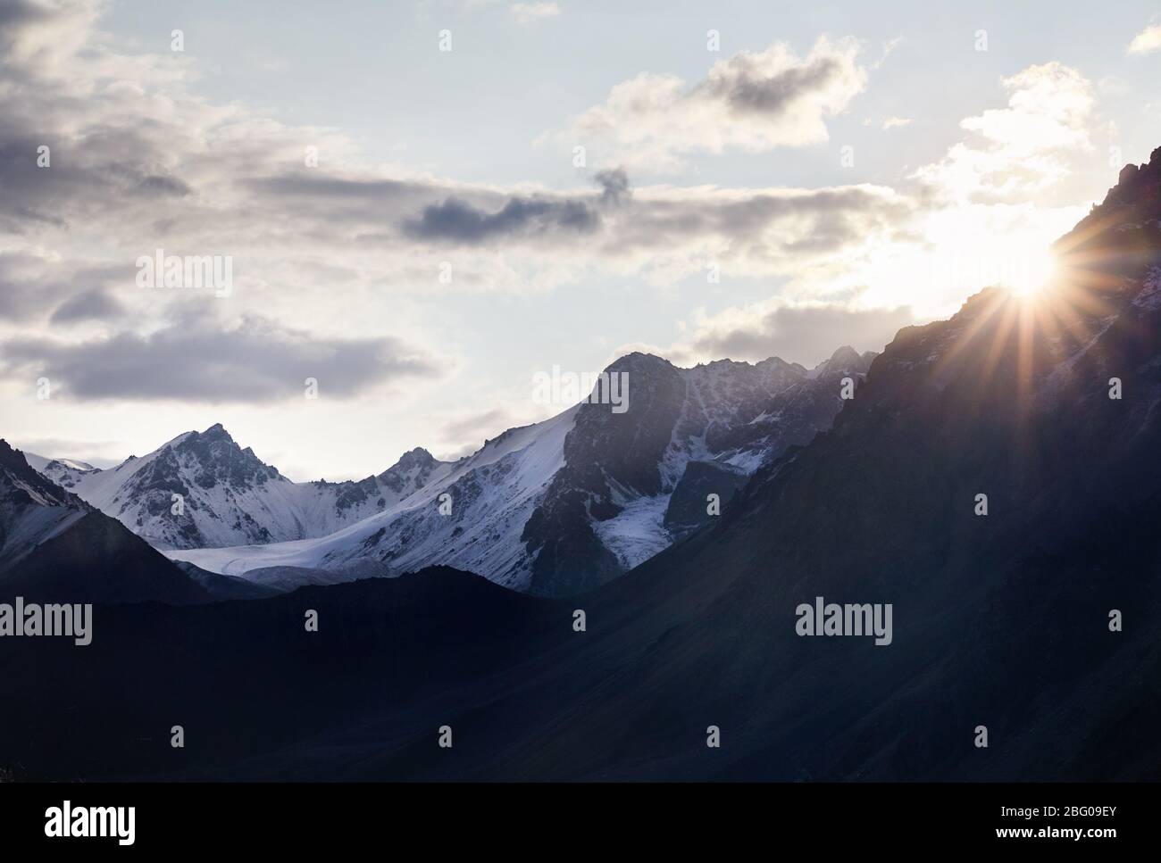 Beautiful landscape of snowy mountains with rising sun in Kazakhstan ...
