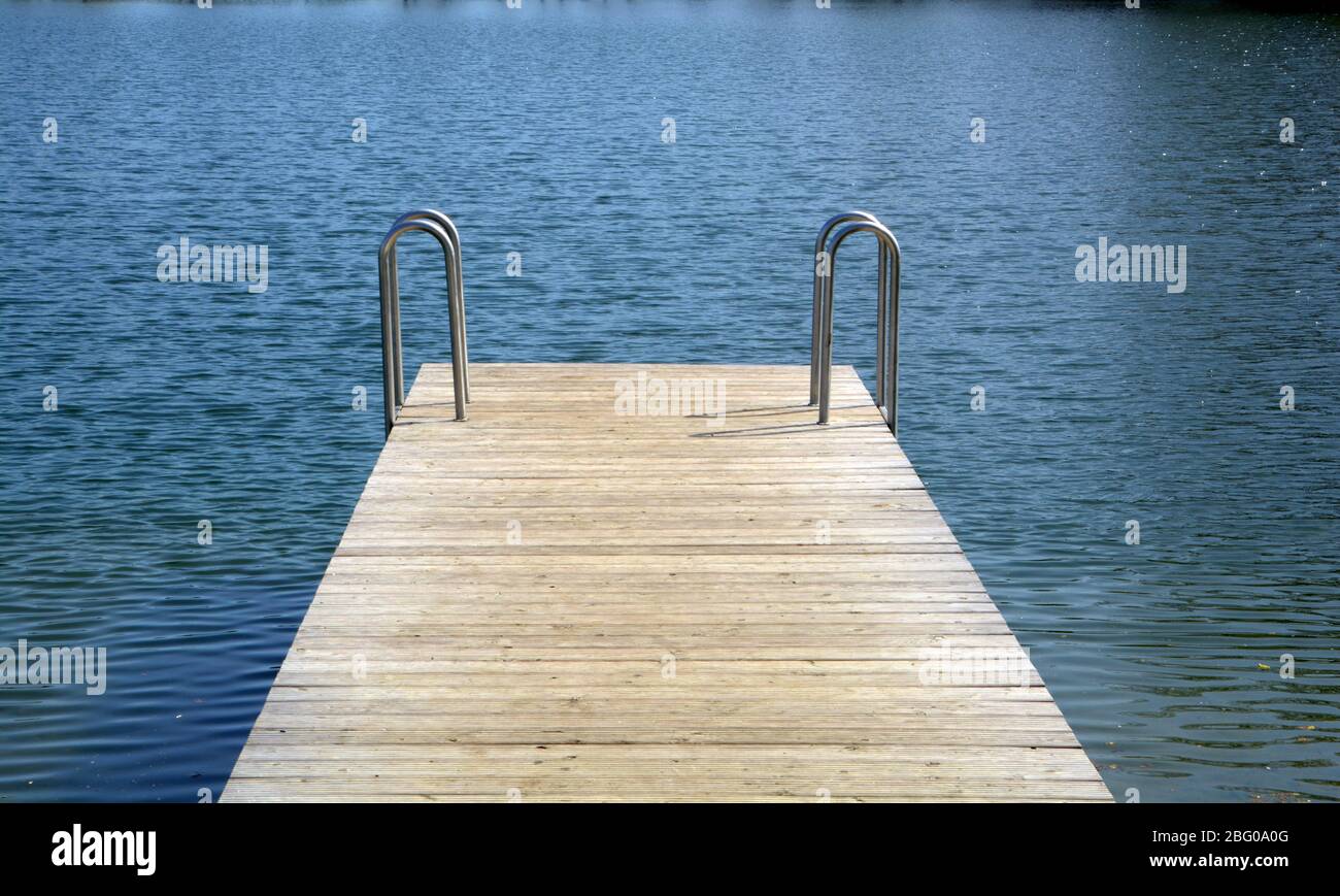 jetty of swimming lake in focus in early summer Stock Photo - Alamy