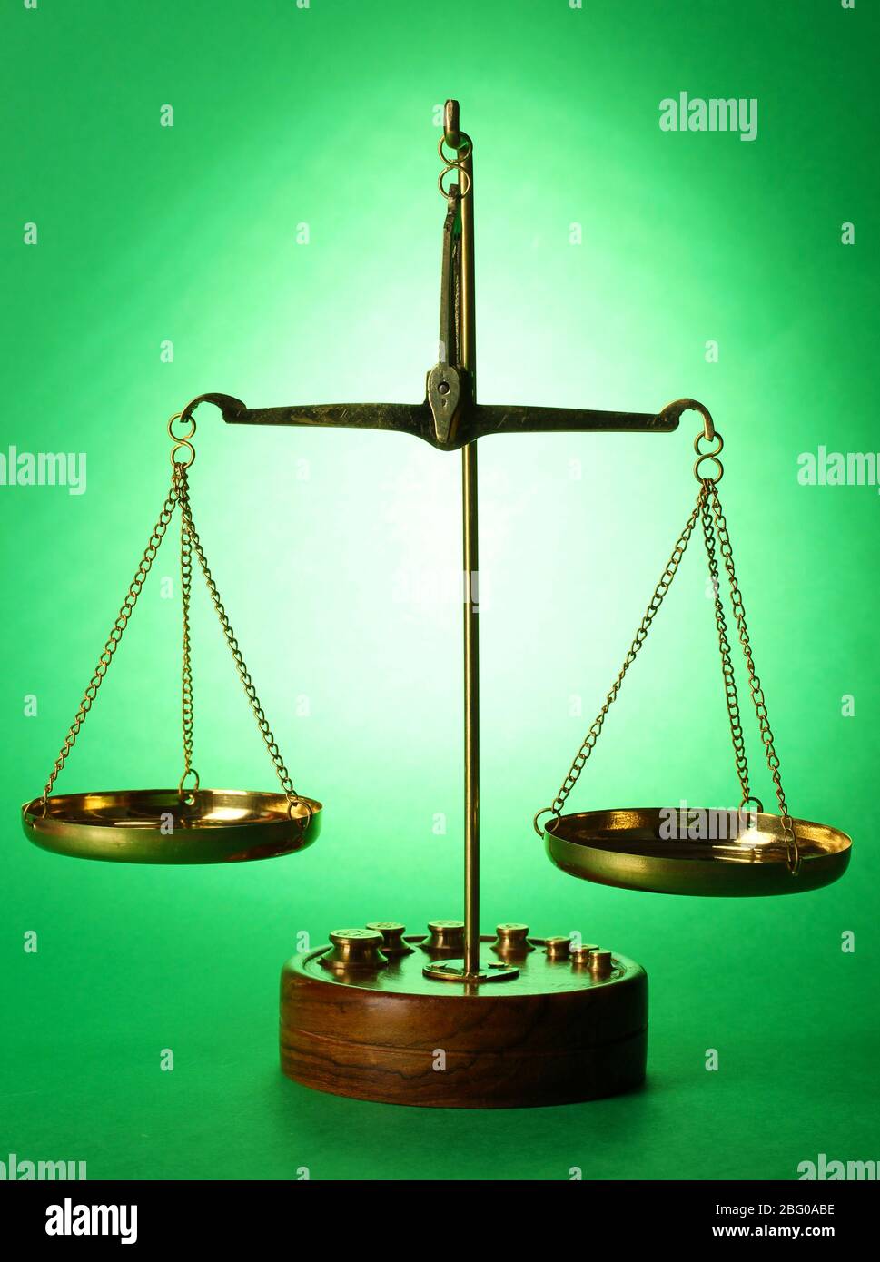 Classic scales on green background Stock Photo - Alamy