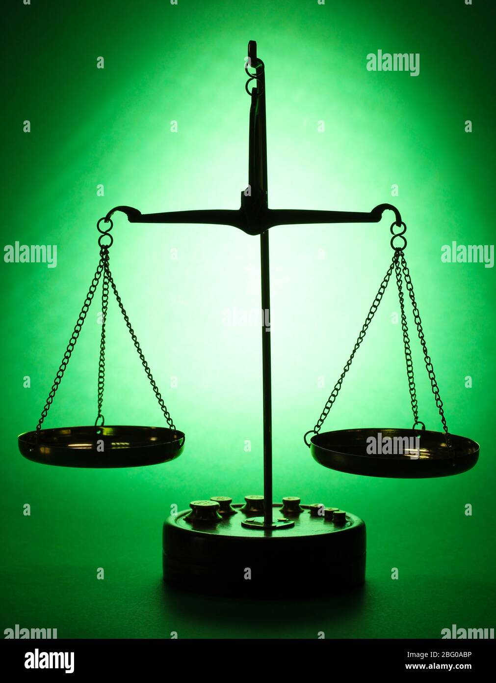 Classic scales on green background Stock Photo - Alamy