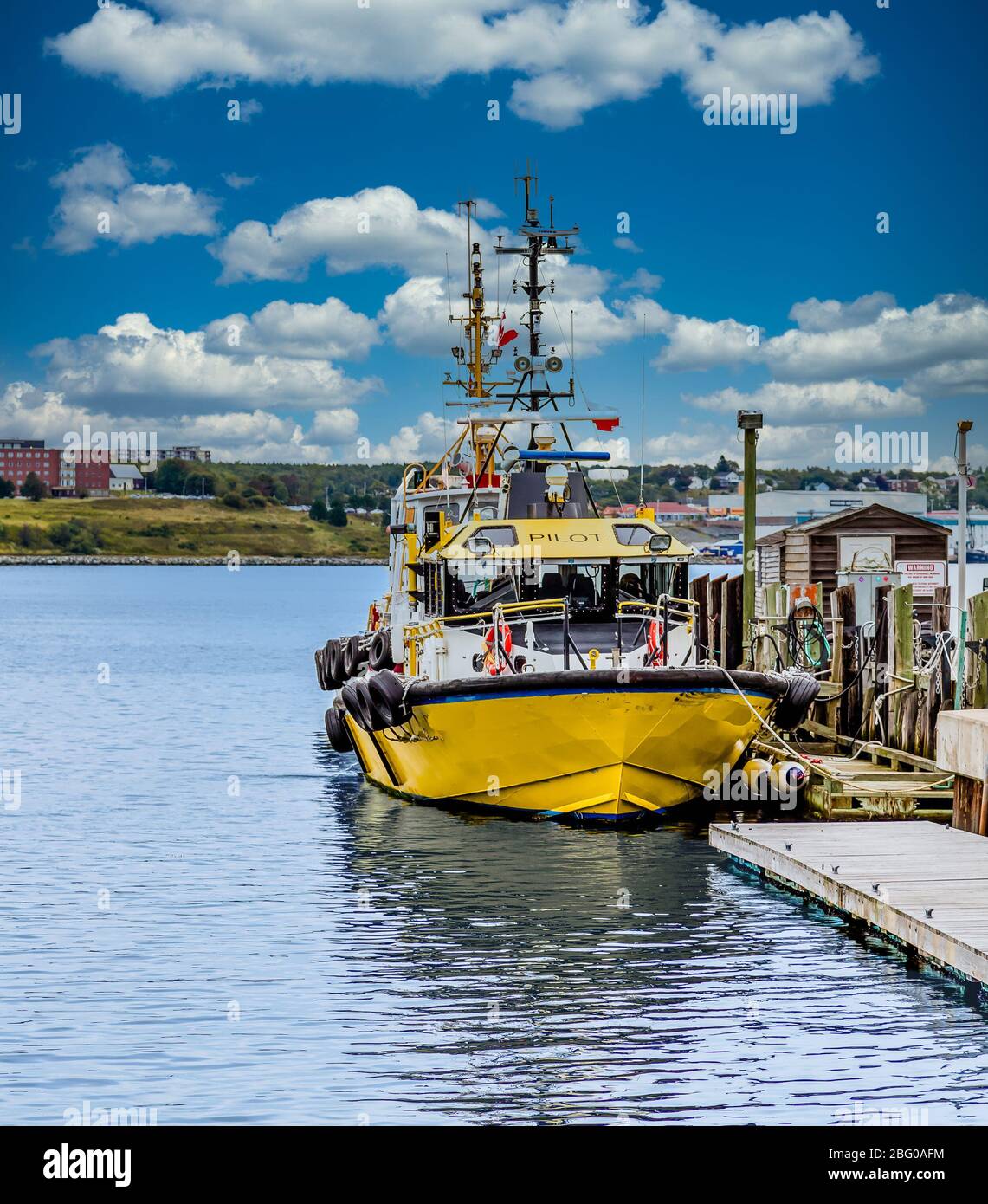 A yellow pilot boat docked at a harbor in Halifax Stock Photo - Alamy