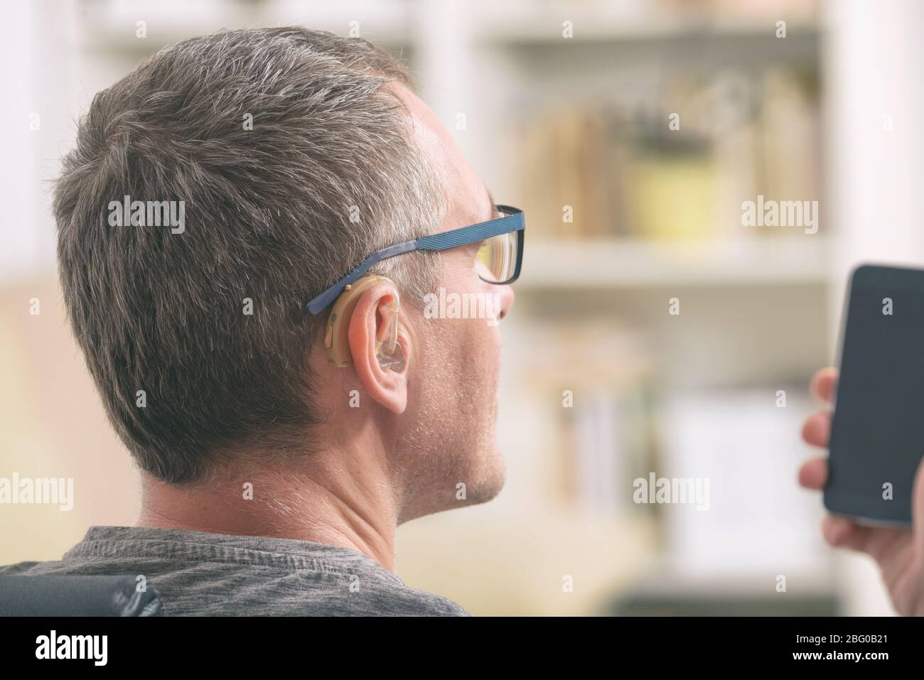 Smiling Deaf man talking using sign language on the smart phone's cam ...