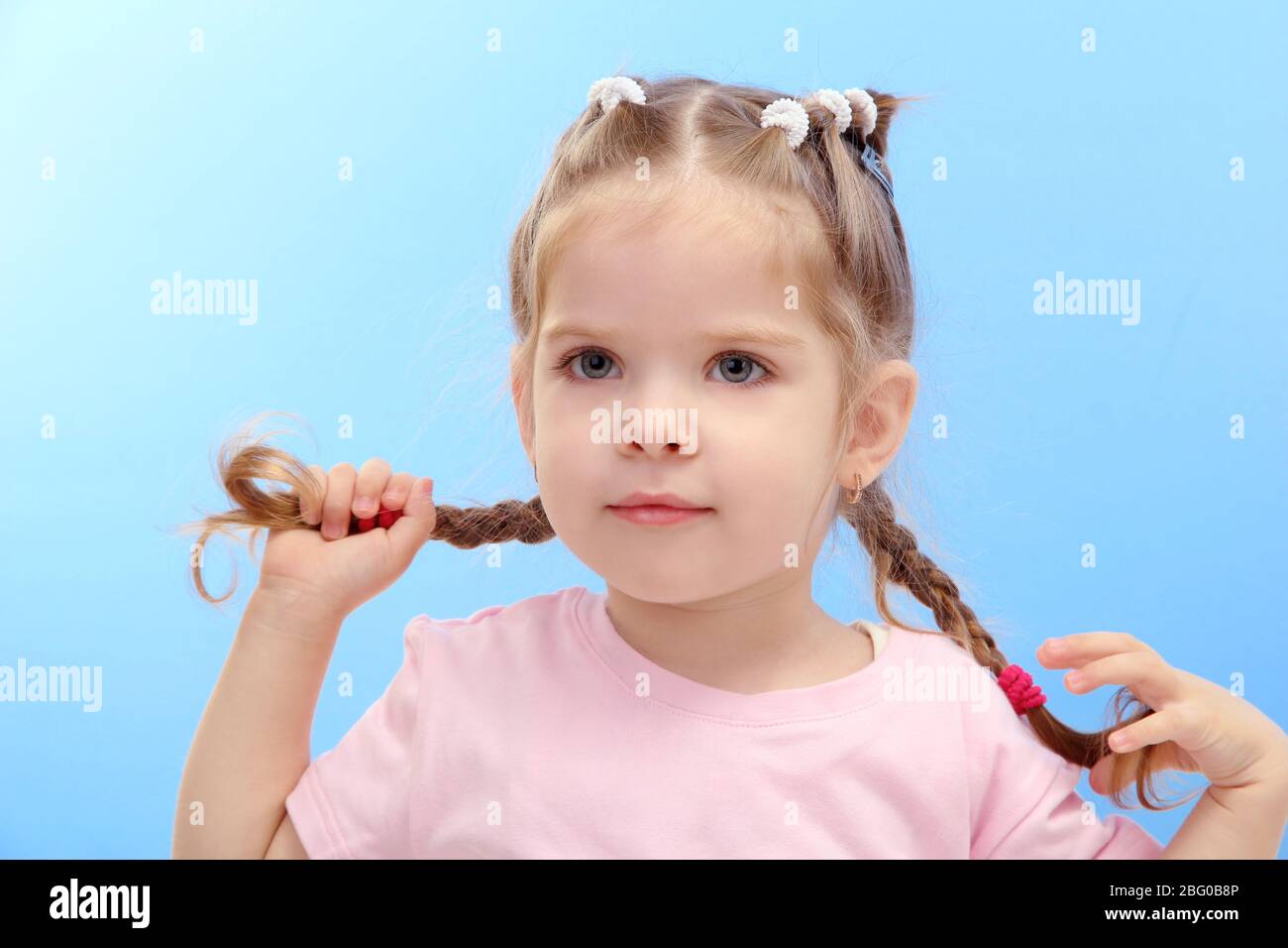 cute little girl, on blue background Stock Photo - Alamy