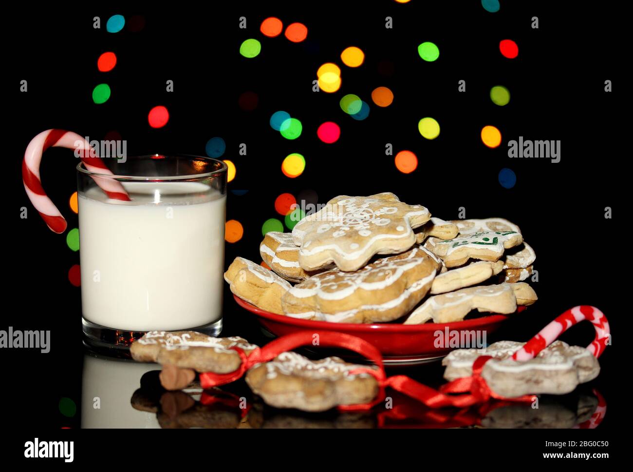 Christmas treats with glass of milk on Christmas lights background ...