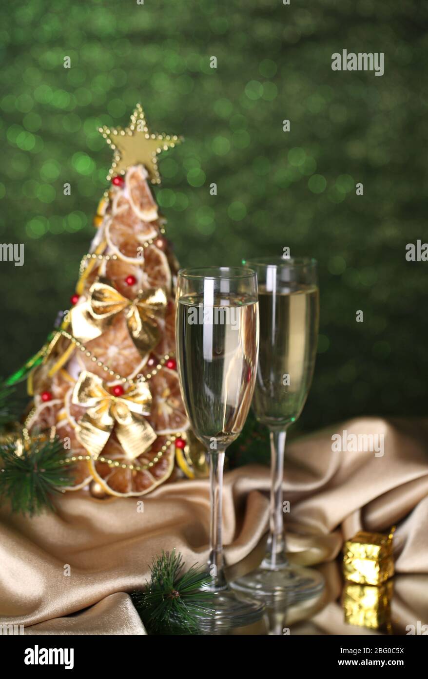 beautiful christmas tree and glasses of champagne on shine green ...