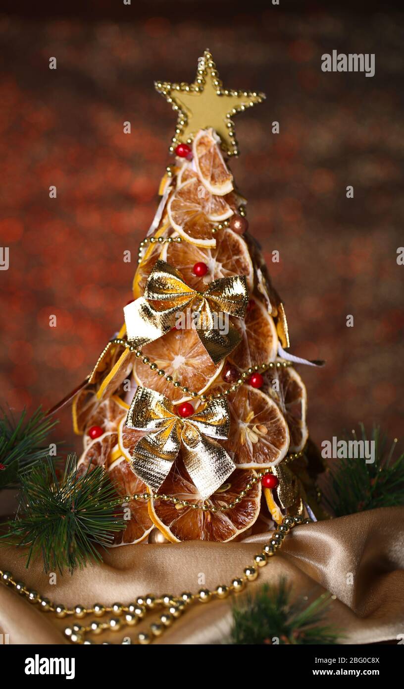 beautiful christmas tree of dry lemons with decor, on shine red ...