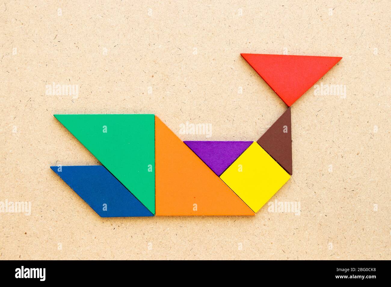 Color tangram puzzle in shark or whale shape on wood background Stock ...