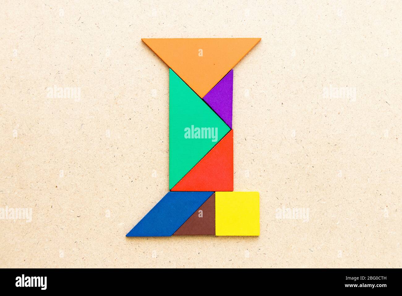 Tangram puzzle in alphabet letter I shape on wood background Stock ...