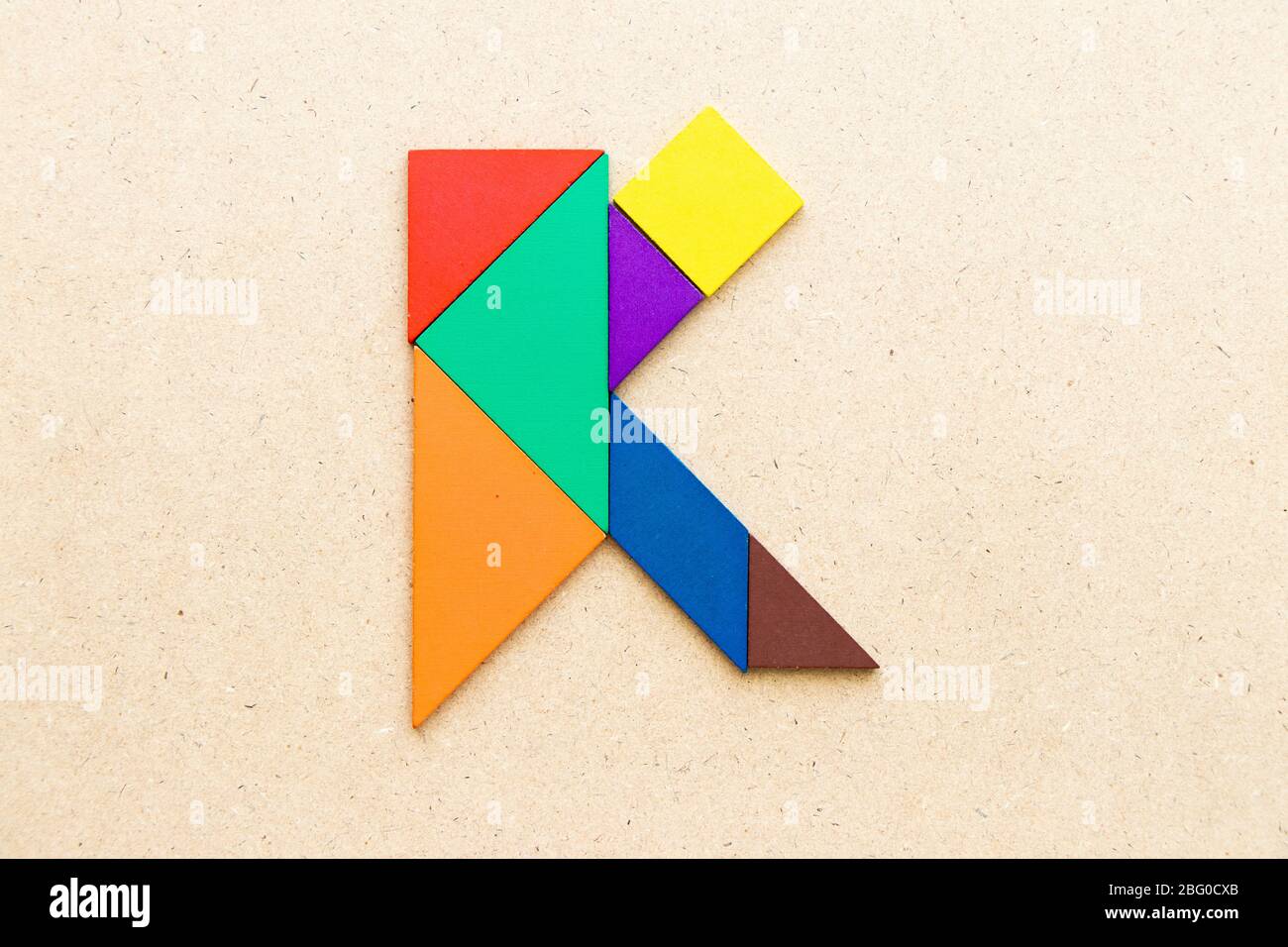 Tangram puzzle in alphabet letter K shape on wood background Stock ...