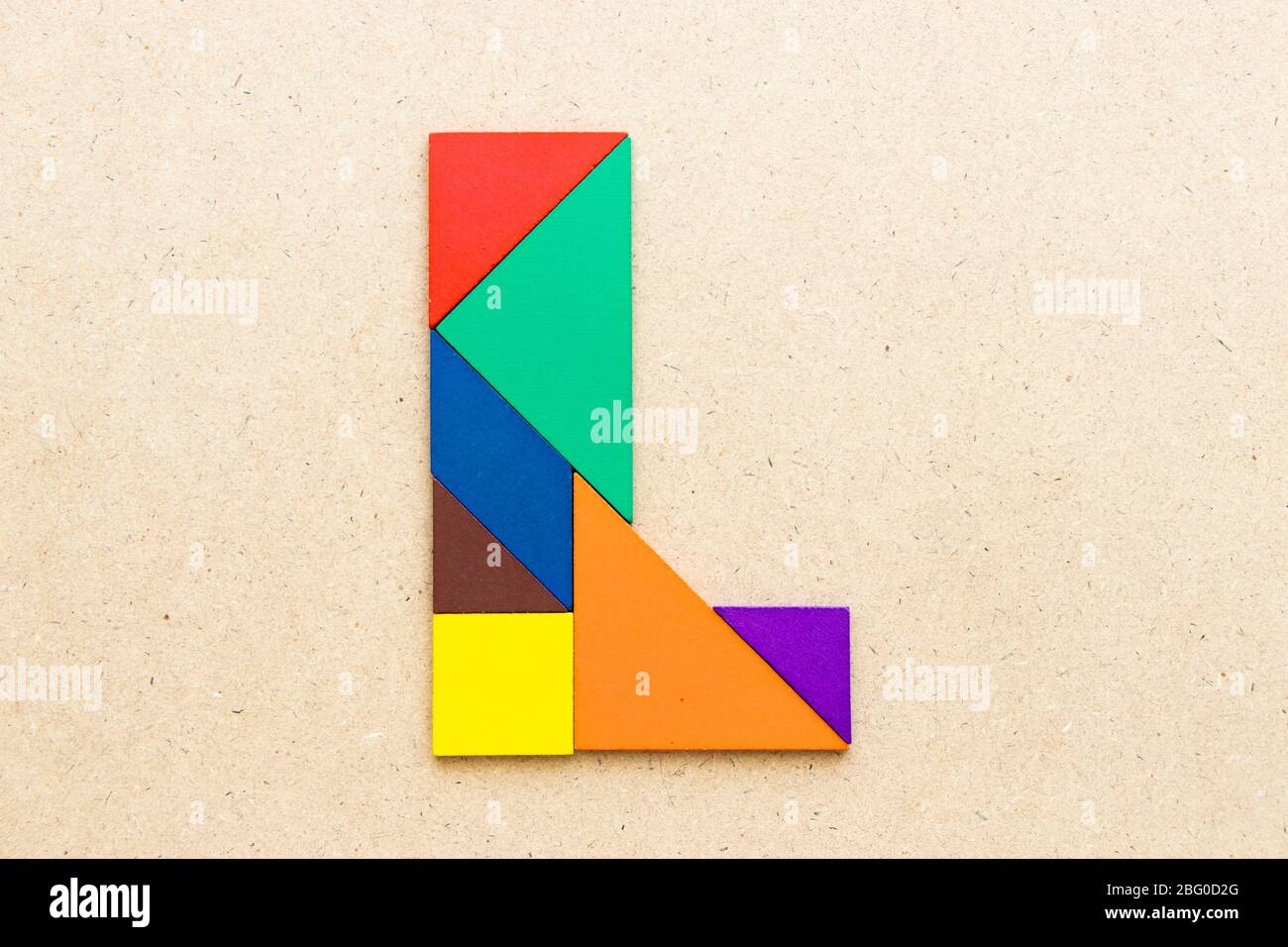 Tangram puzzle in alphabet letter L shape on wood background Stock ...