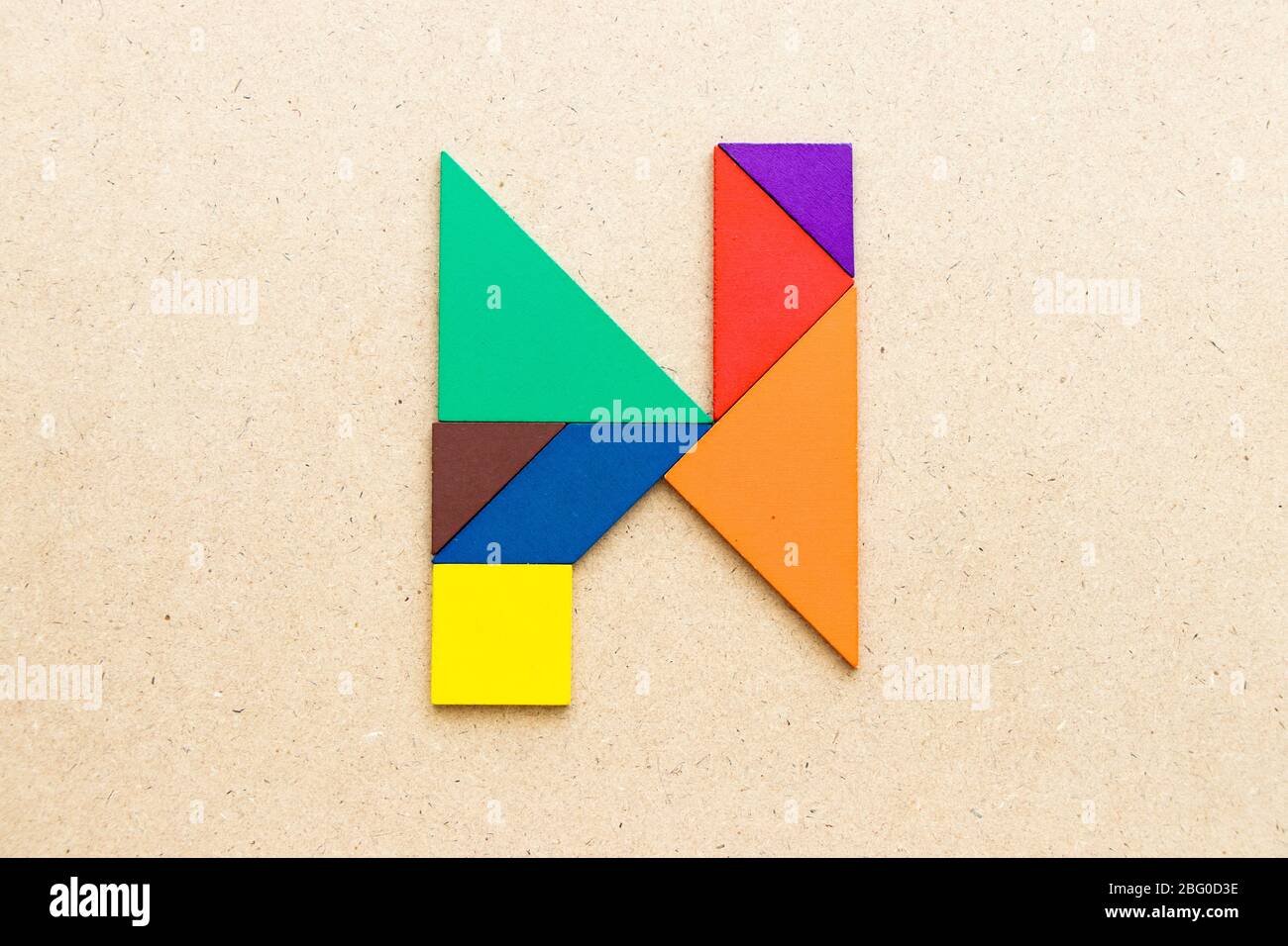 Tangram puzzle in alphabet letter N shape on wood background Stock ...
