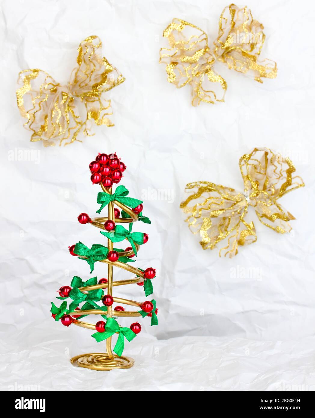 Wire Christmas tree on crumpled paper background Stock Photo - Alamy
