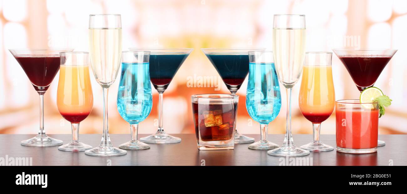Several glasses of different drinks on bright background Stock Photo ...