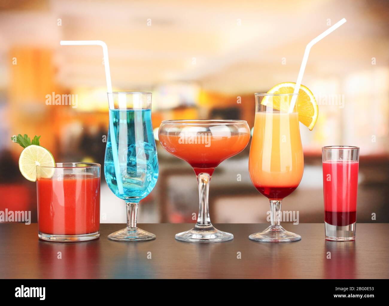 Several glasses of different drinks on bright background Stock Photo ...