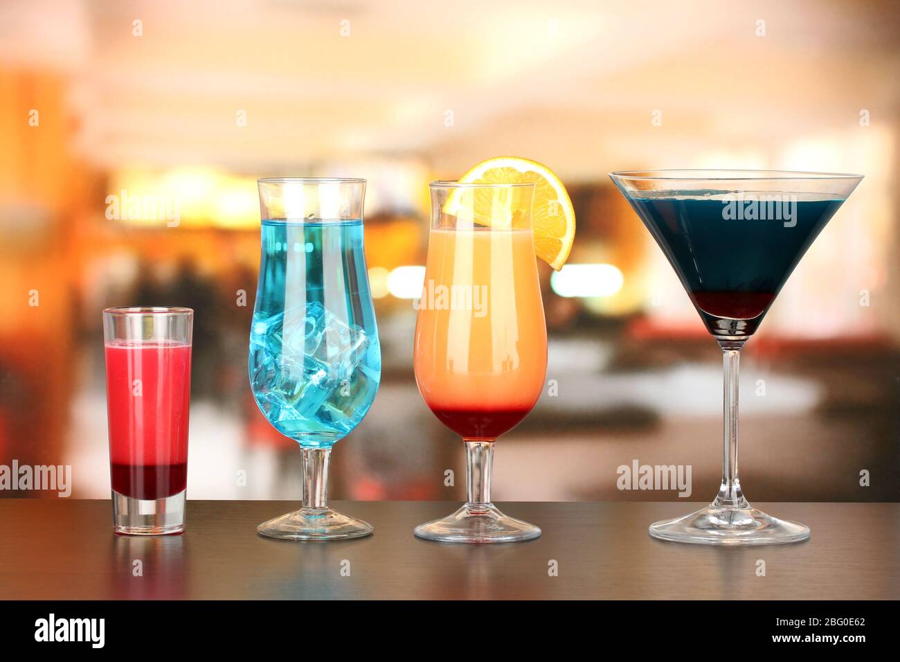 Several glasses of different drinks on bright background Stock Photo ...