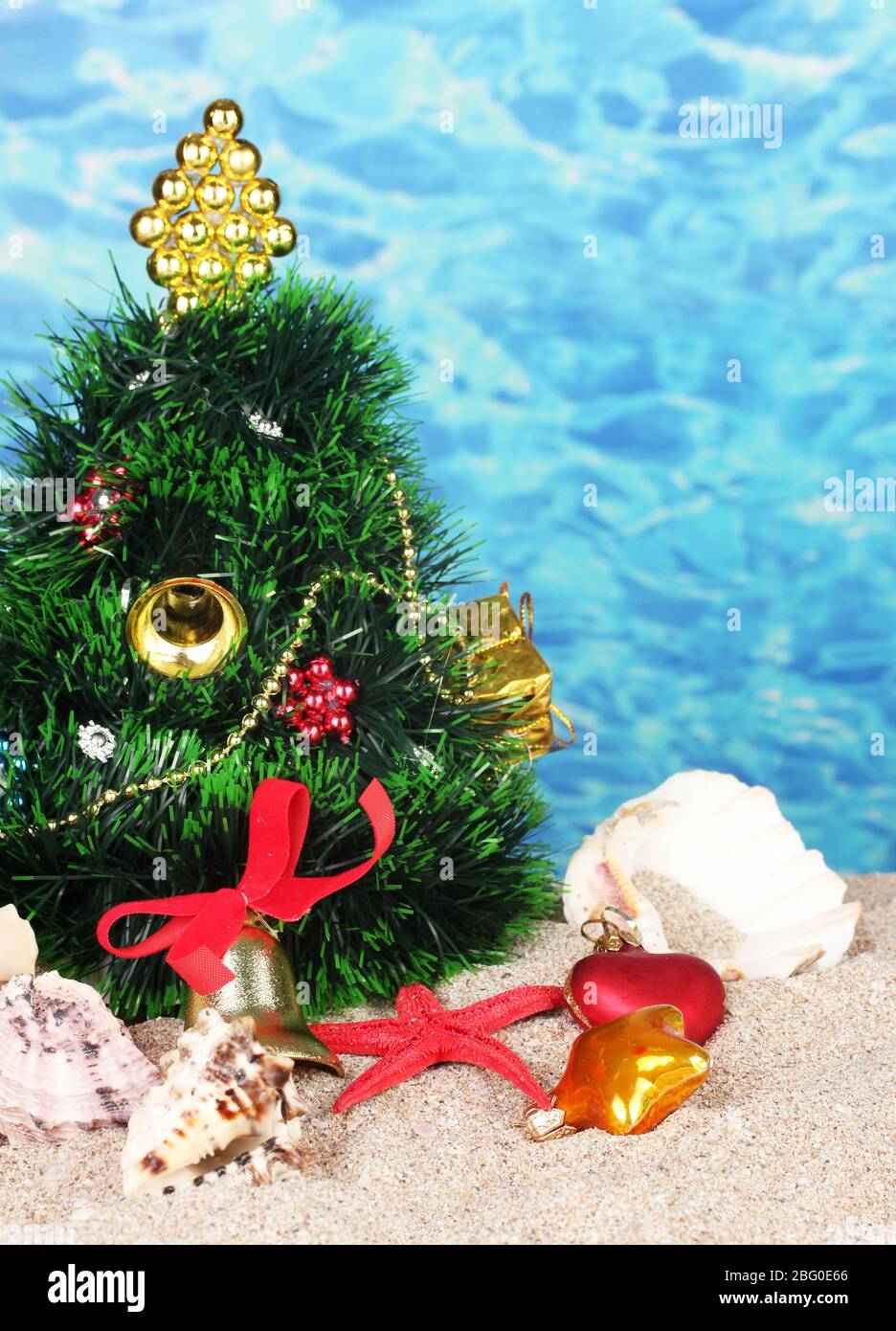 Christmas tree on sand in beach Stock Photo - Alamy