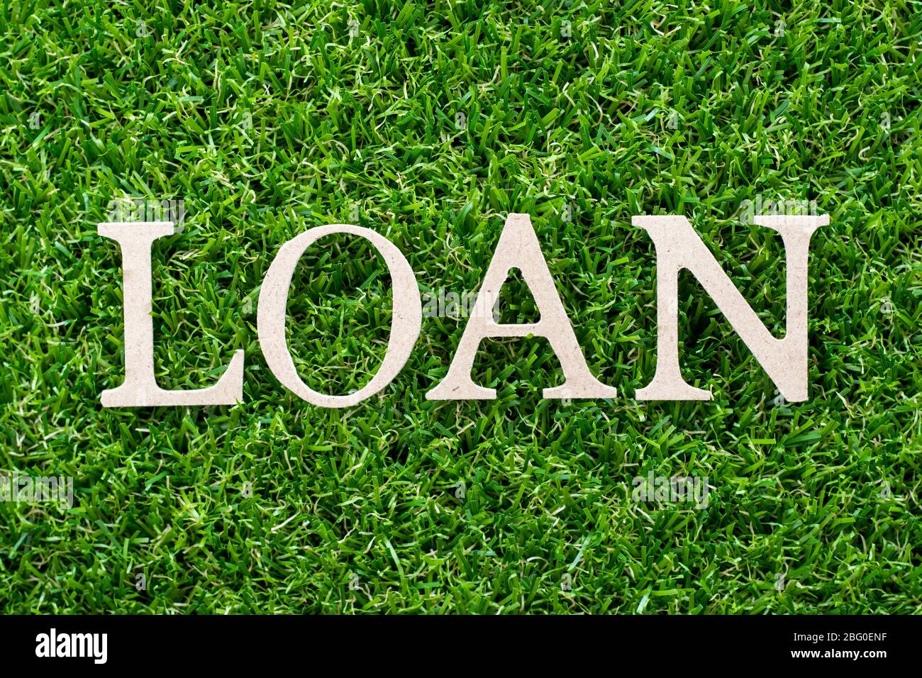 Wood letter in word loan on artificial green grass background Stock ...