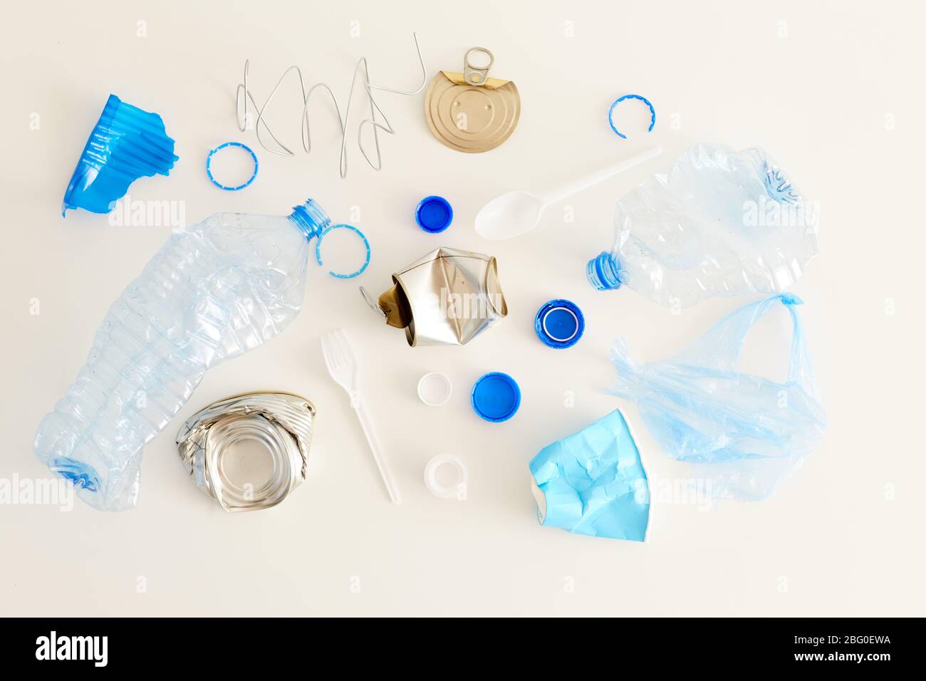 Above view of various trash items laid in minimal composition on white ...