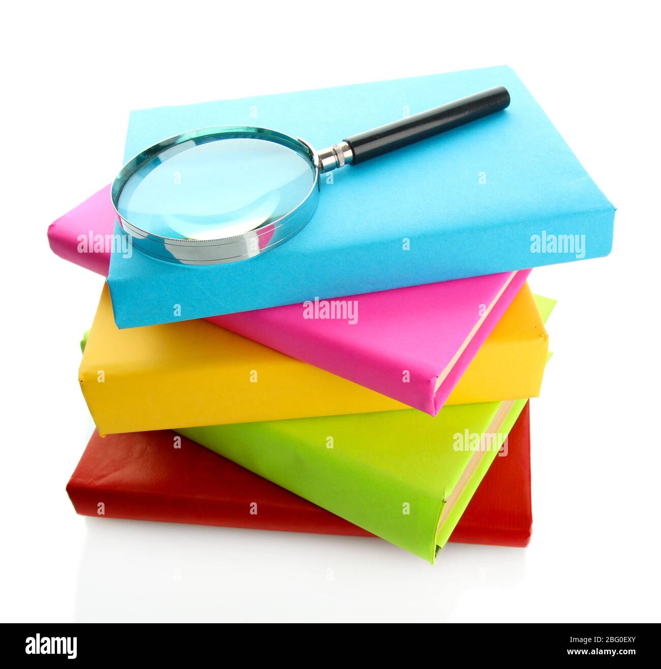 color books with magnifying glass isolated on white Stock Photo - Alamy