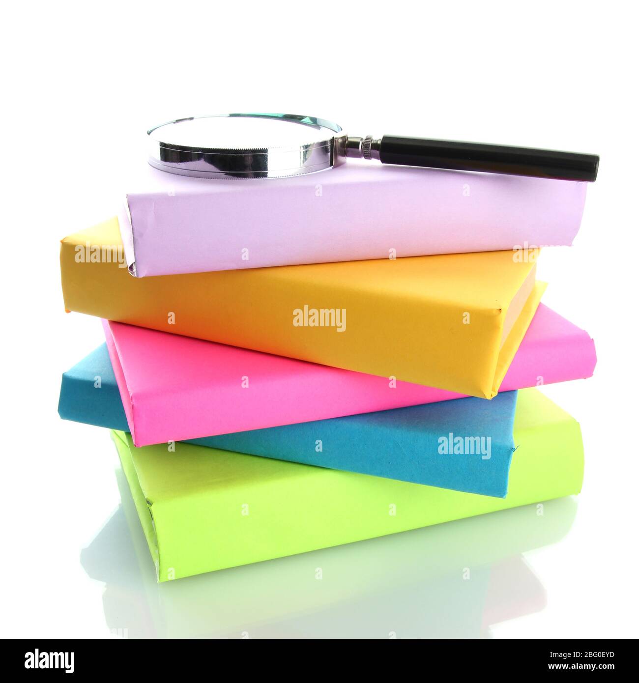 color books with magnifying glass isolated on white Stock Photo - Alamy