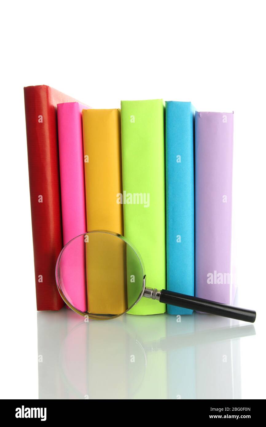 color books with magnifying glass isolated on white Stock Photo - Alamy