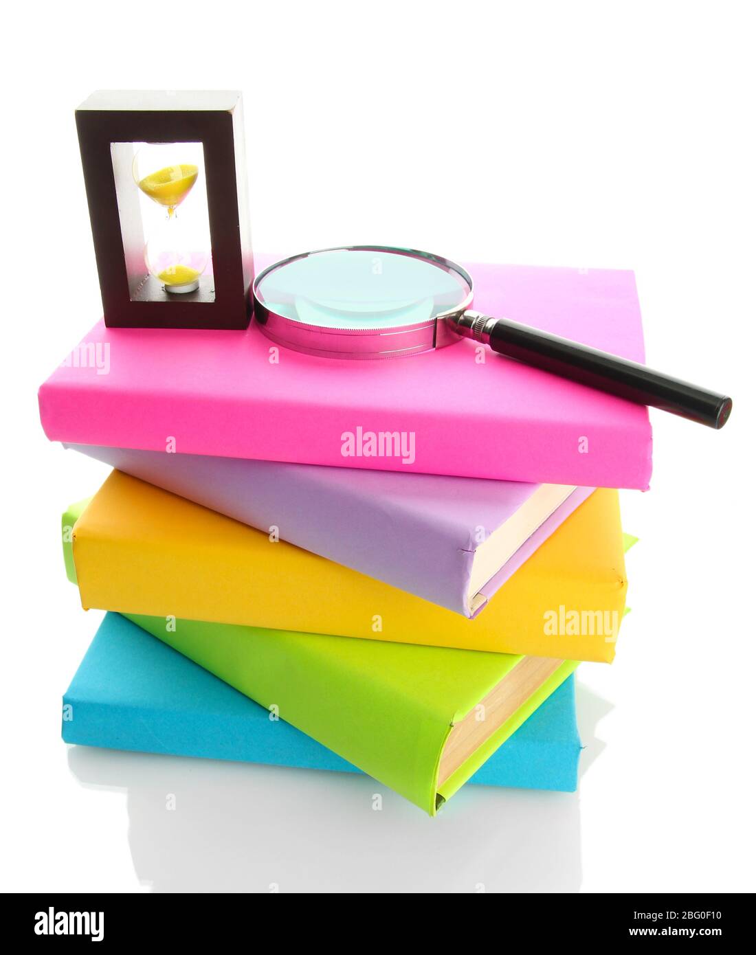 color books with magnifying glass isolated on white Stock Photo - Alamy