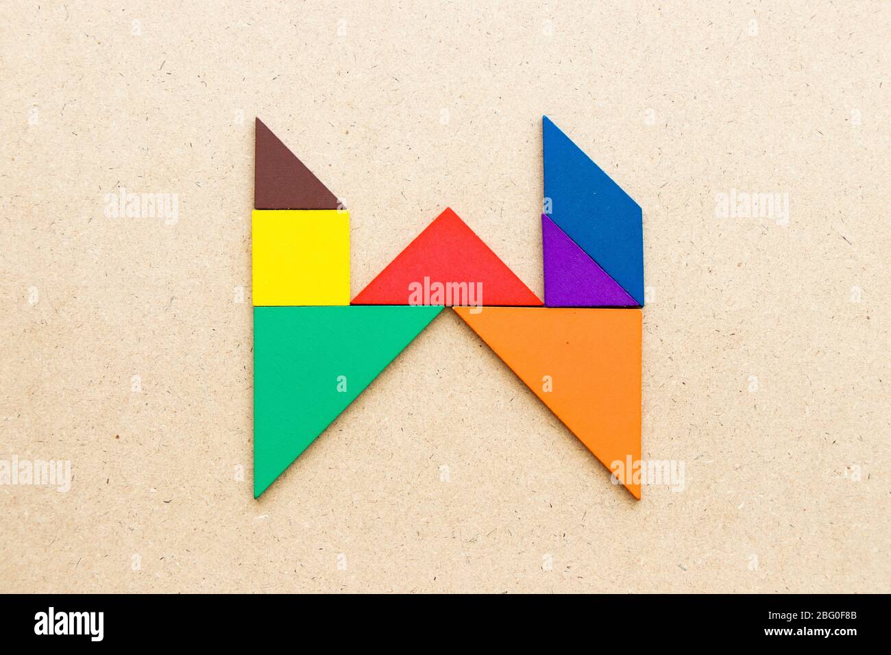 Tangram puzzle in alphabet letter W shape on wood background Stock ...