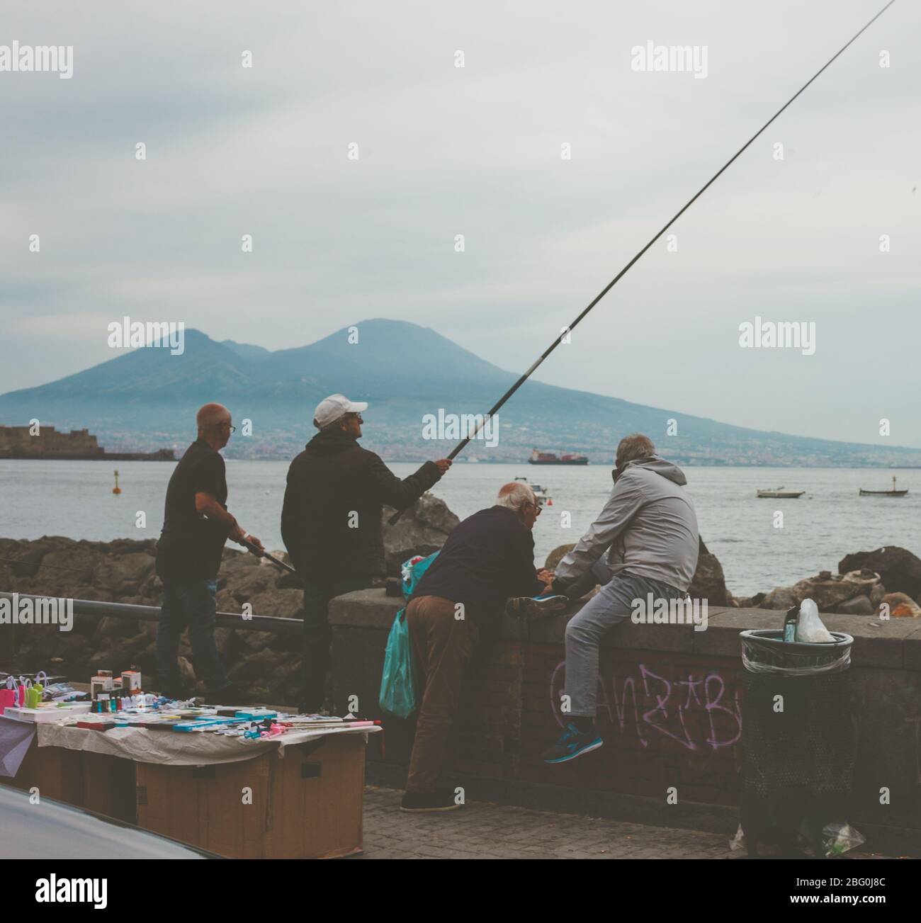 Old fisherman with friends. Classic Italian scene in Napoli Stock Photo ...