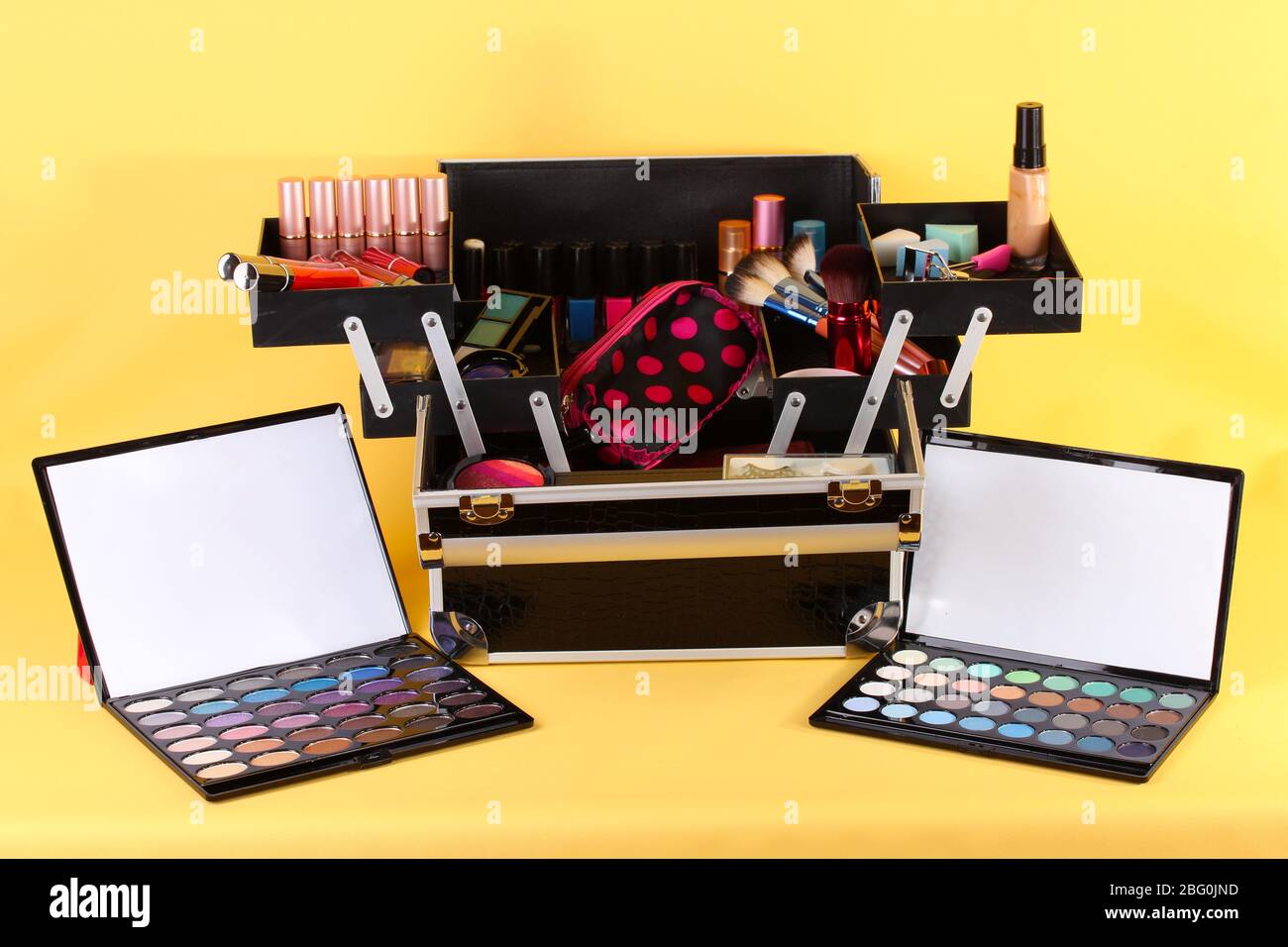 open case with cosmetics on yellow background Stock Photo - Alamy