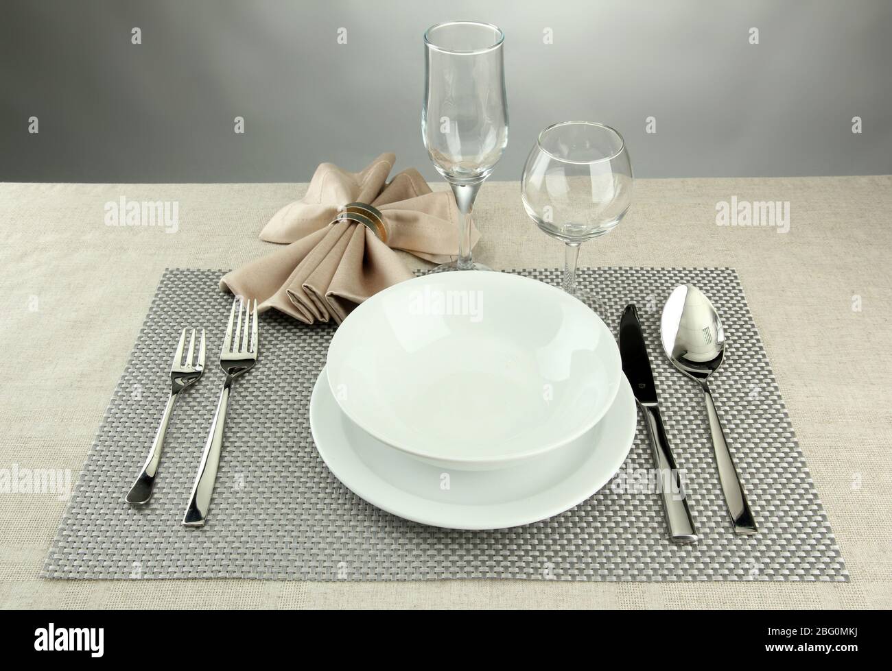 Table setting, on grey background Stock Photo - Alamy