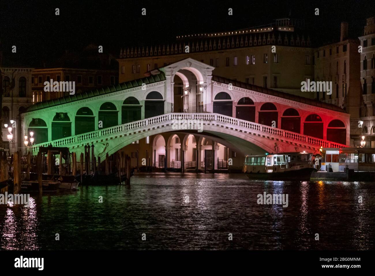 VENICE, ITALY - APRIL 17 Rialto Bridge illuminated with the colors of ...