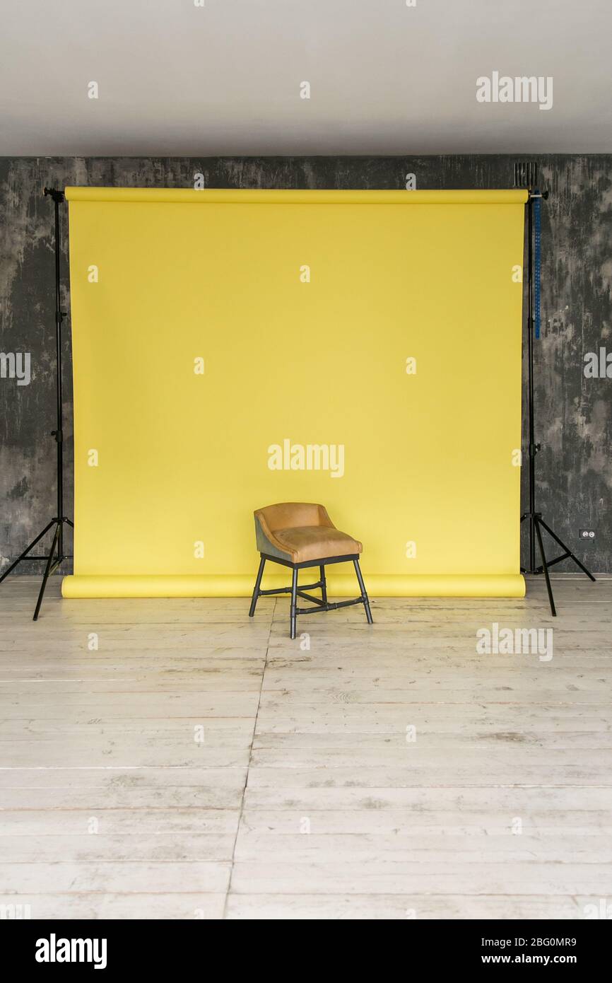 The working space of the photo studio with a yellow paper background ...