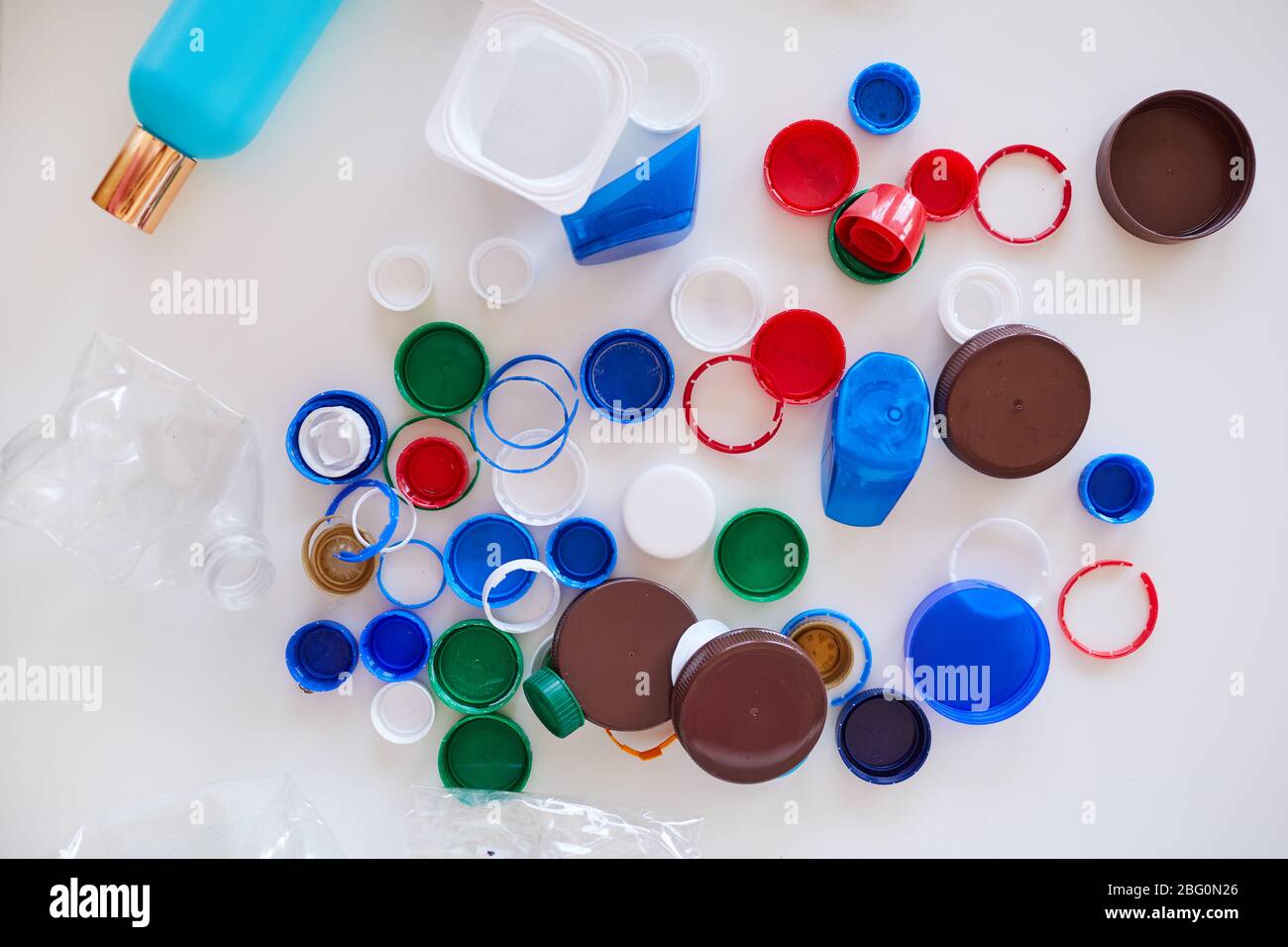 Top view background of various plastic items on white background, waste ...