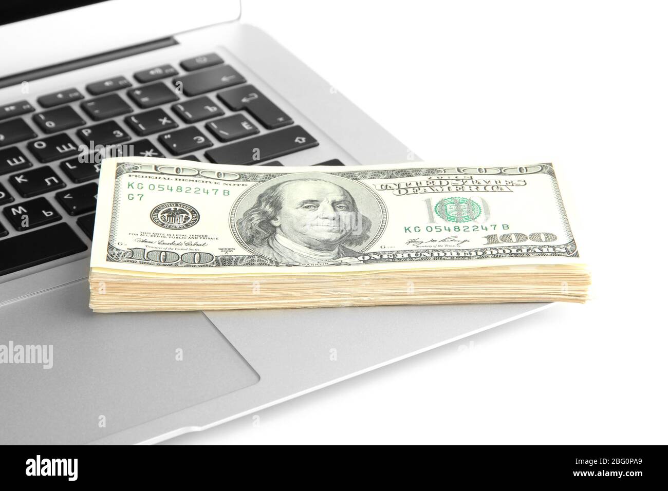 Money on laptop isolated on white Stock Photo - Alamy