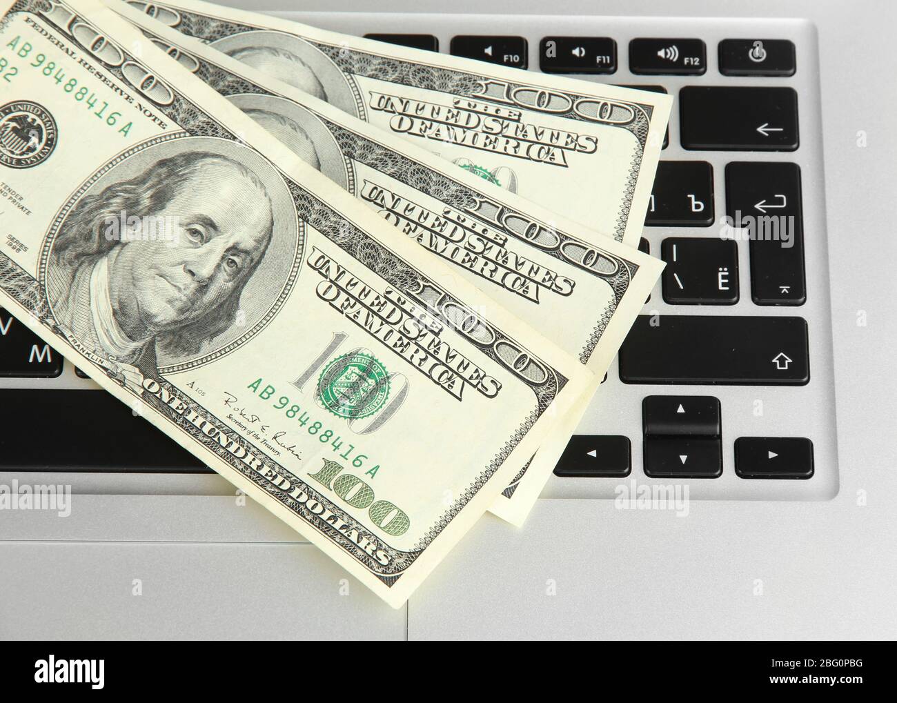 Money on laptop close hi-res stock photography and images - Alamy