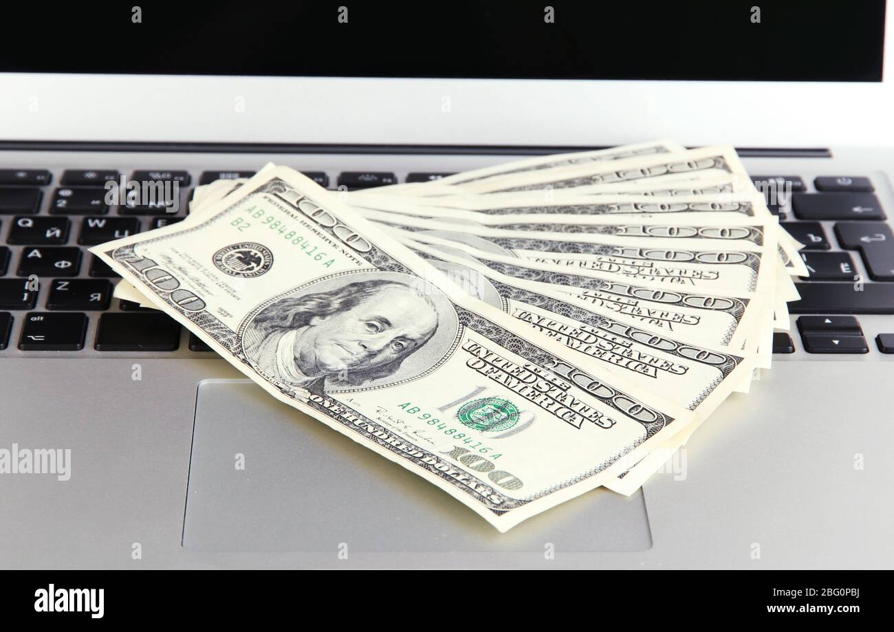 Money on laptop close hi-res stock photography and images - Alamy